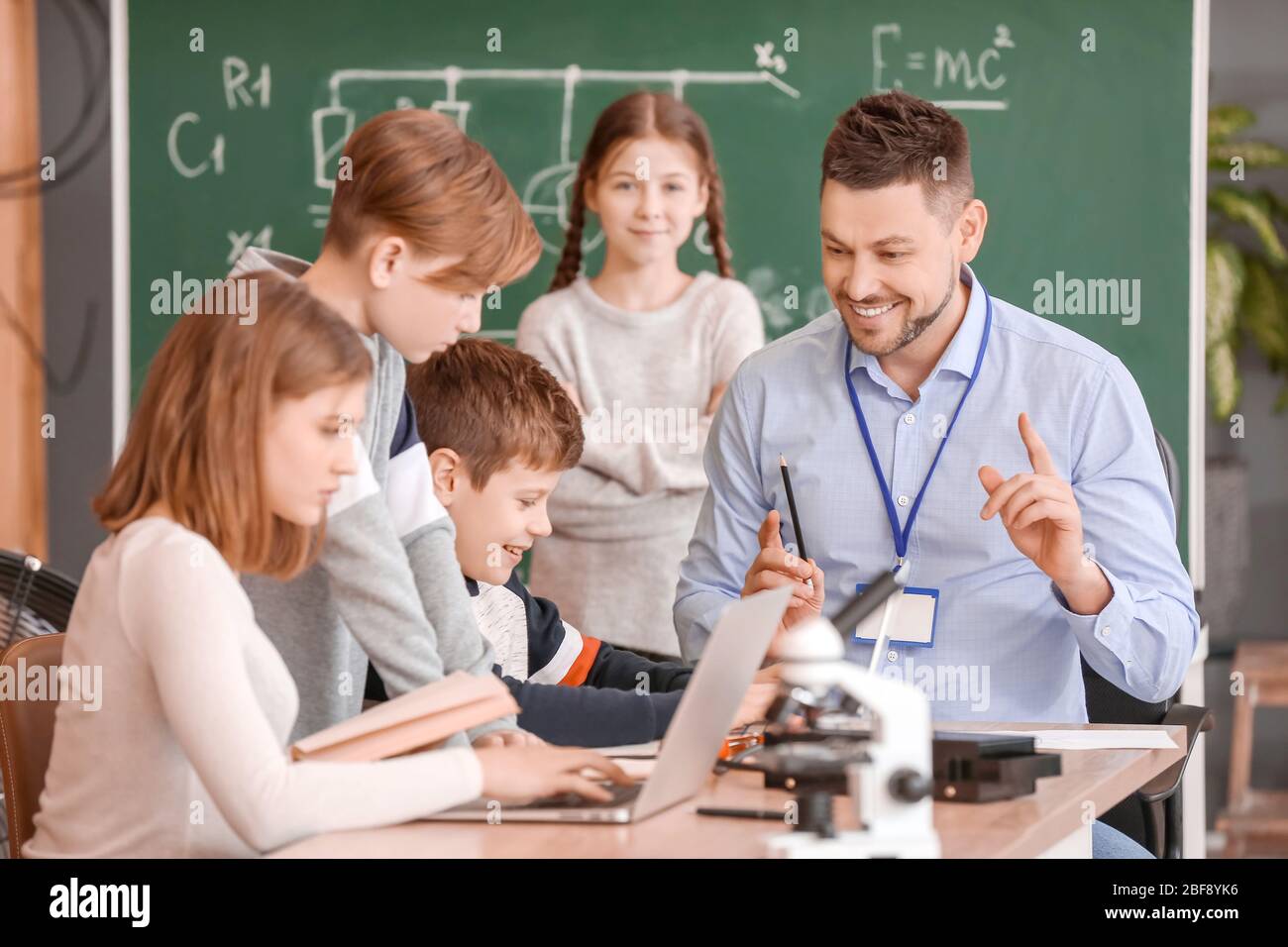 Teacher conducting physics lesson in classroom Stock Photo - Alamy