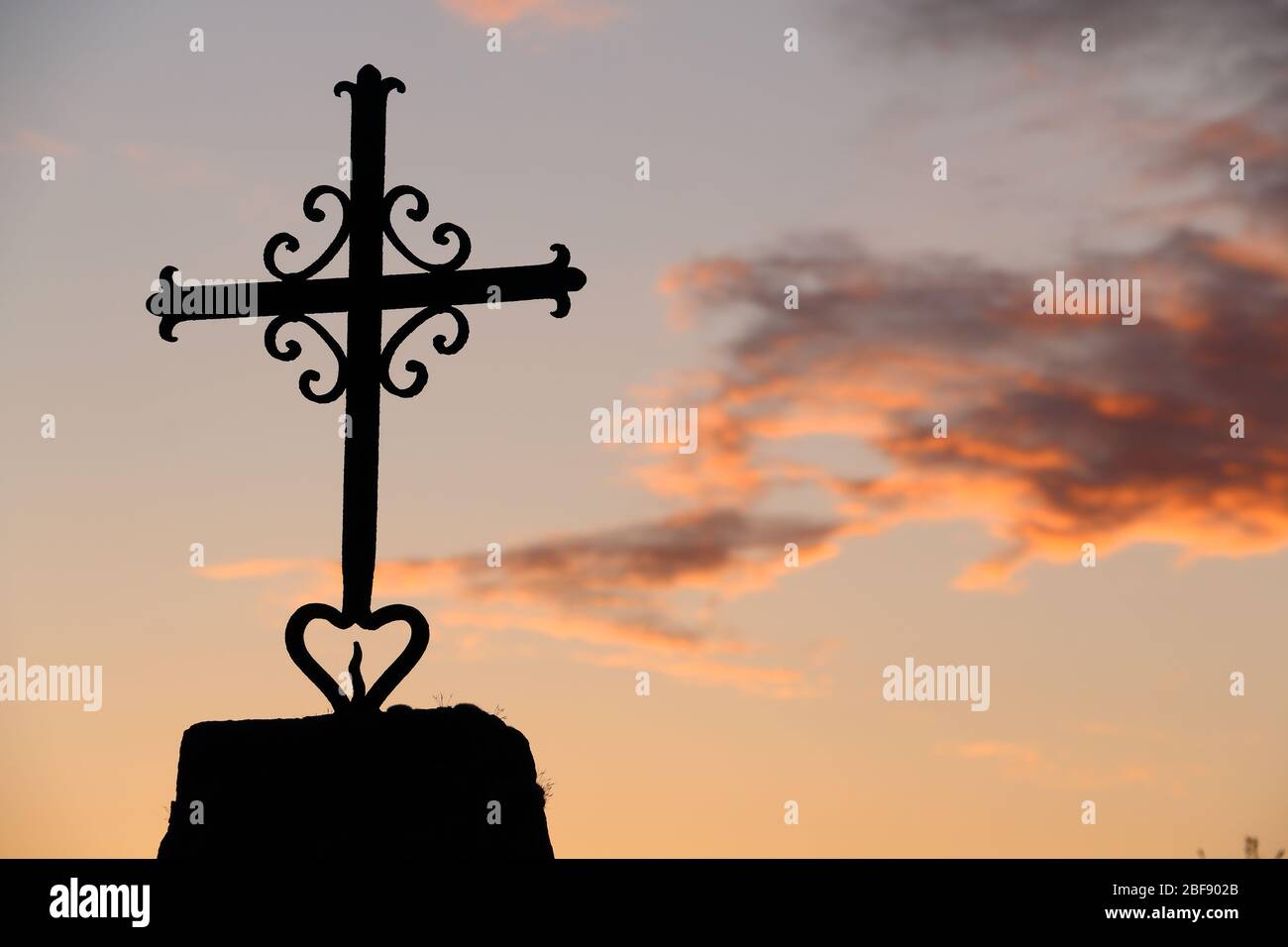 Iron made christian cross outdoor. Sunset sky background Stock Photo ...