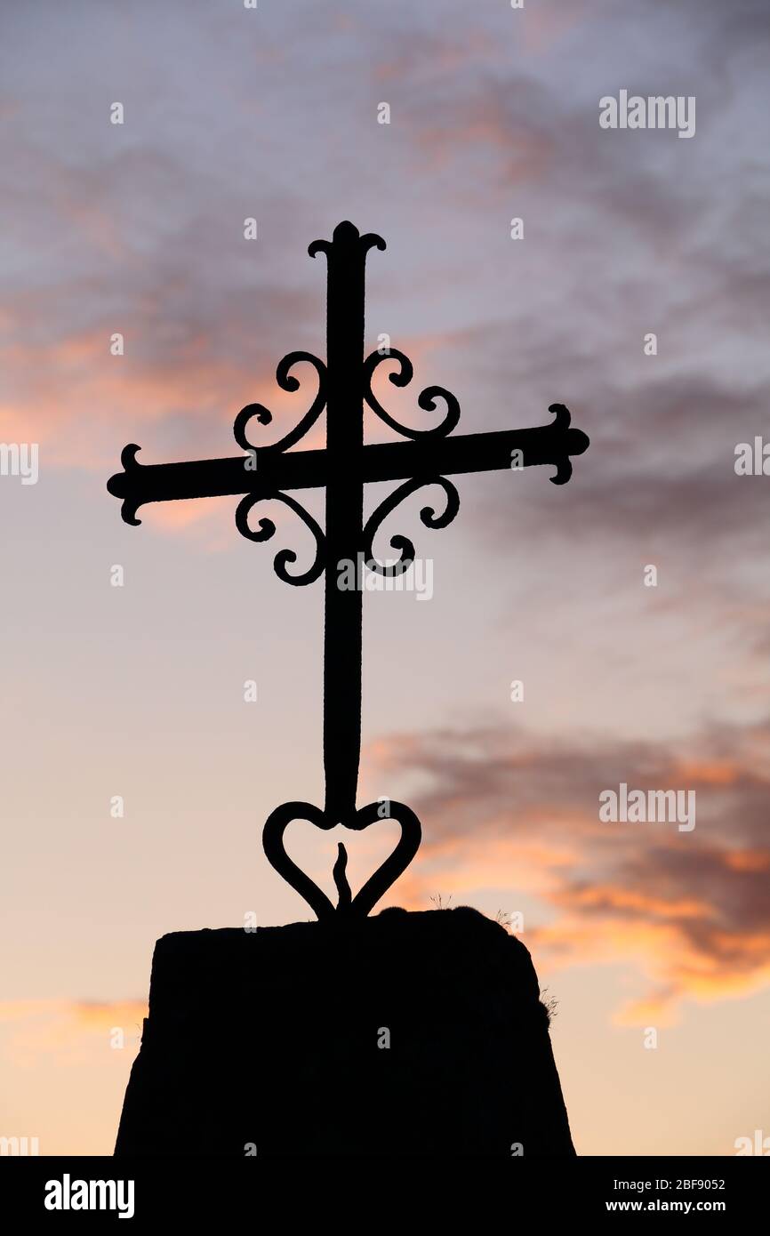 Iron made christian cross outdoor. Sunset sky background. Portrait ...