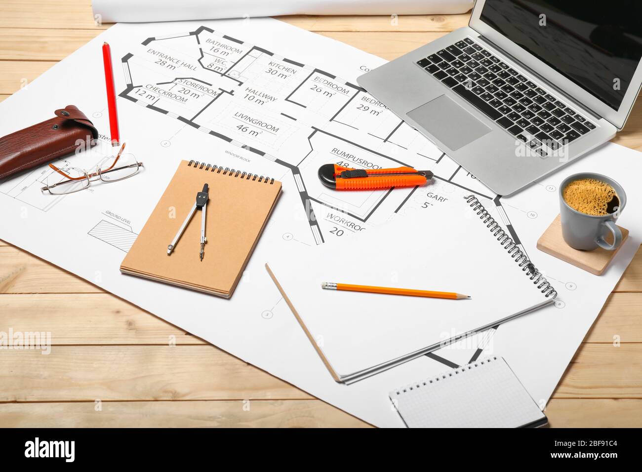 Builder's workplace with laptop and house plan Stock Photo - Alamy