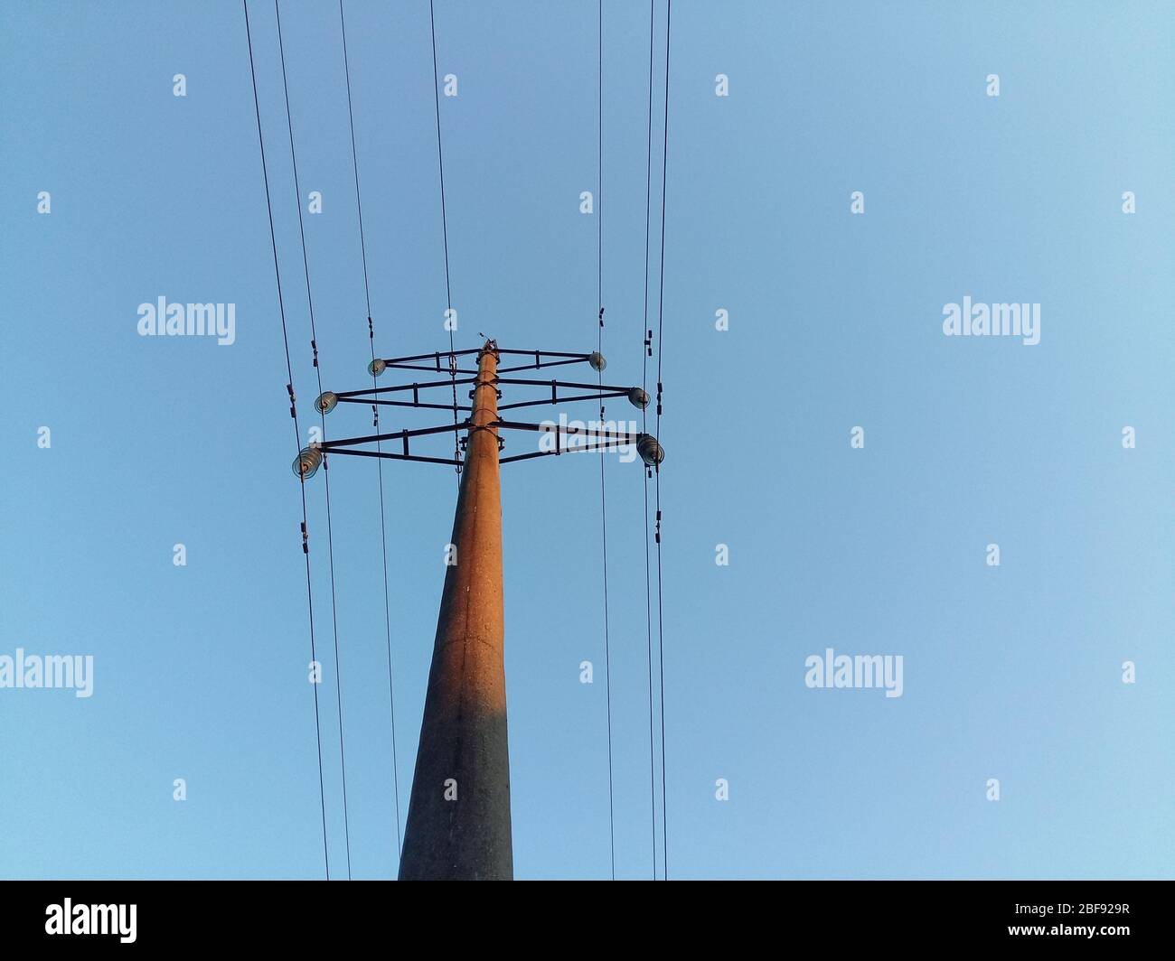 Energy and technology: electrical post by the road with power line ...