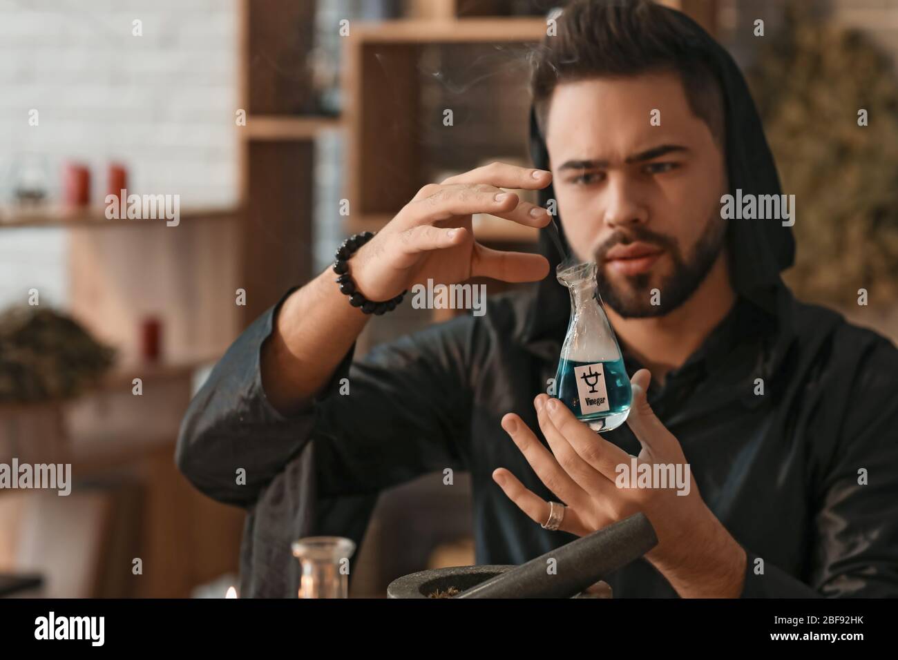 Male alchemist making elixir in laboratory Stock Photo - Alamy
