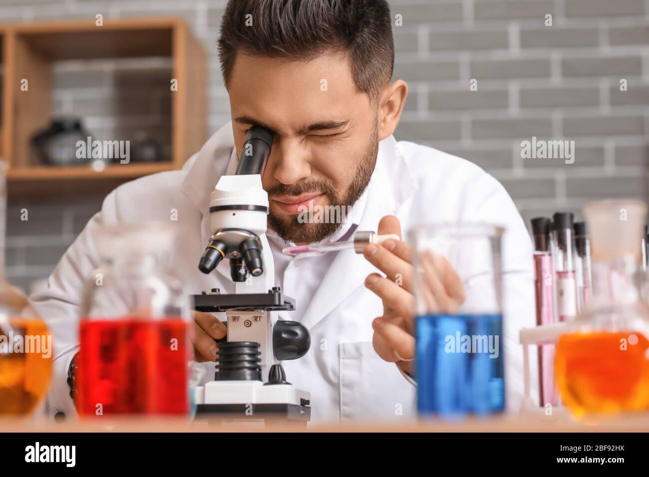 Male alchemist working in laboratory Stock Photo - Alamy
