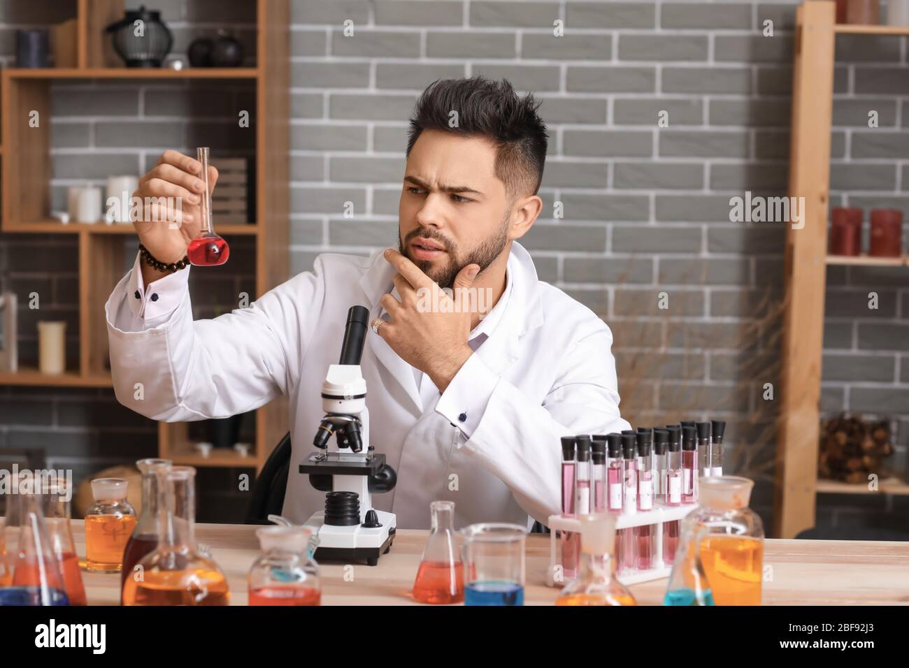 Male alchemist working in laboratory Stock Photo - Alamy