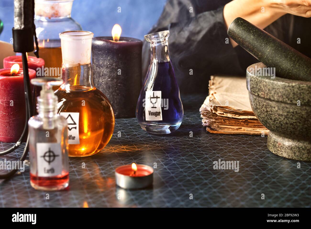 Bottles with potions on table of alchemist Stock Photo - Alamy