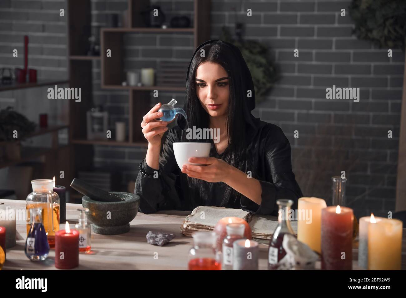 Female alchemist making elixir in laboratory Stock Photo - Alamy