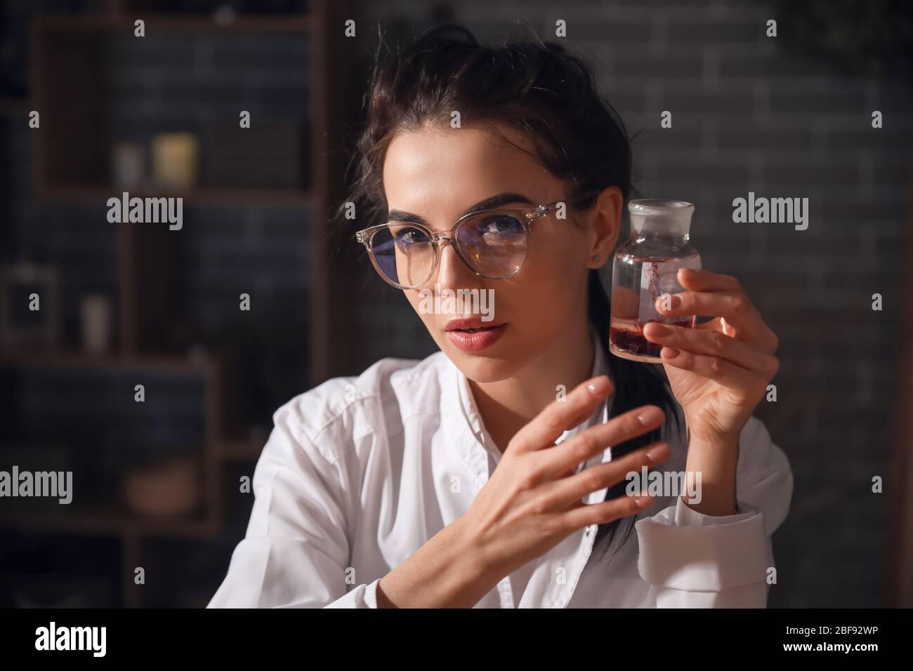 Female alchemist with potion in laboratory Stock Photo - Alamy