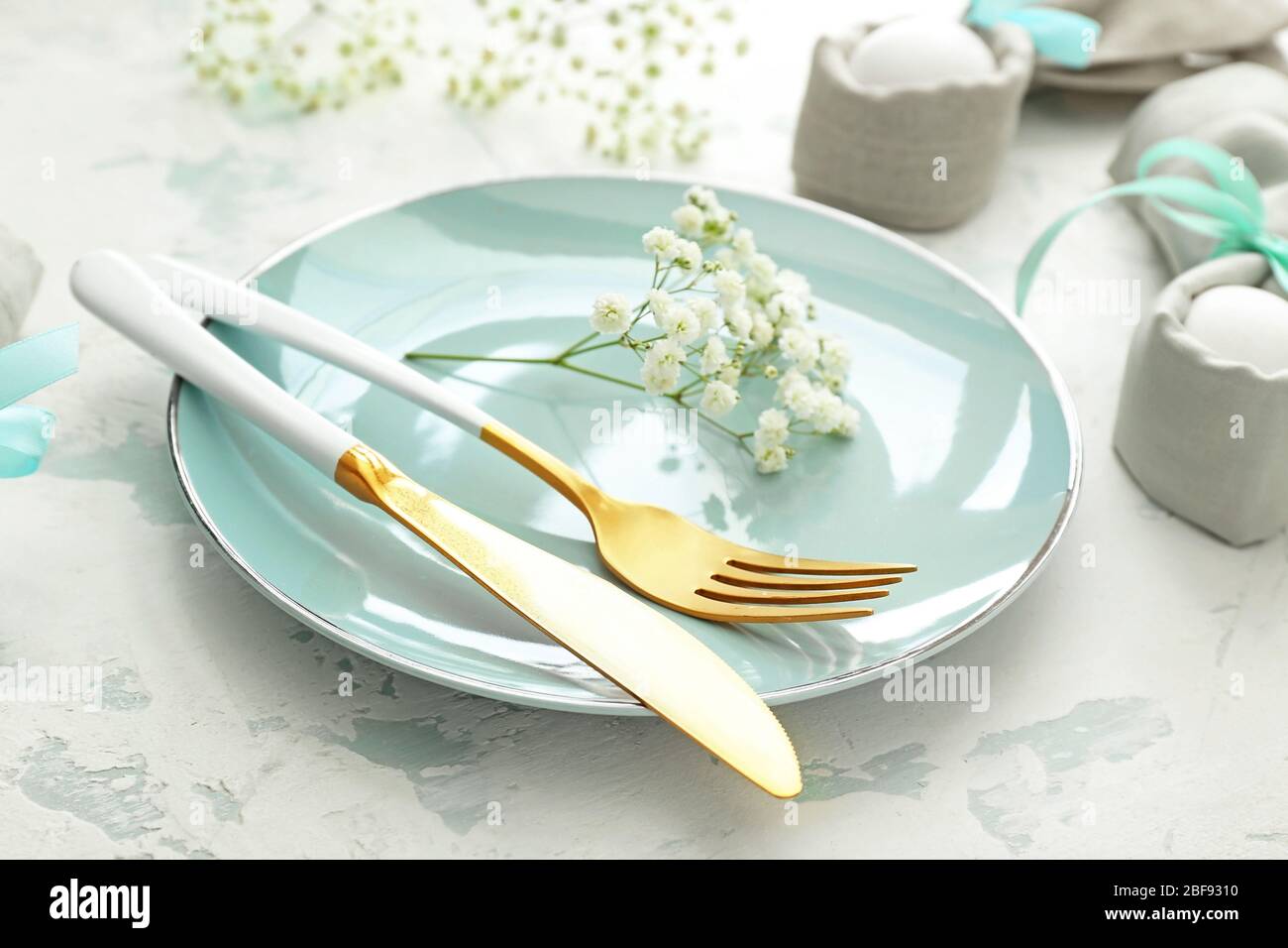Beautiful Easter table setting on white background Stock Photo - Alamy