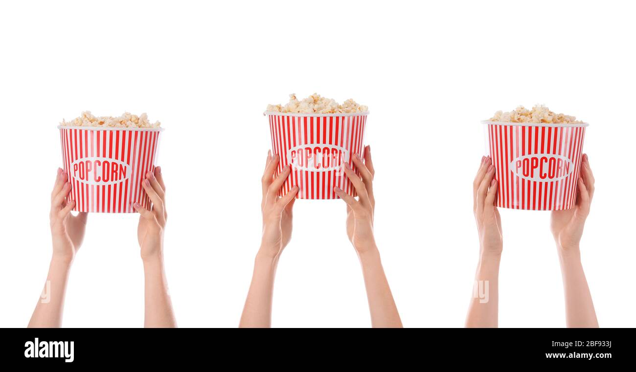 Many hands with popcorn in buckets on white background Stock Photo - Alamy