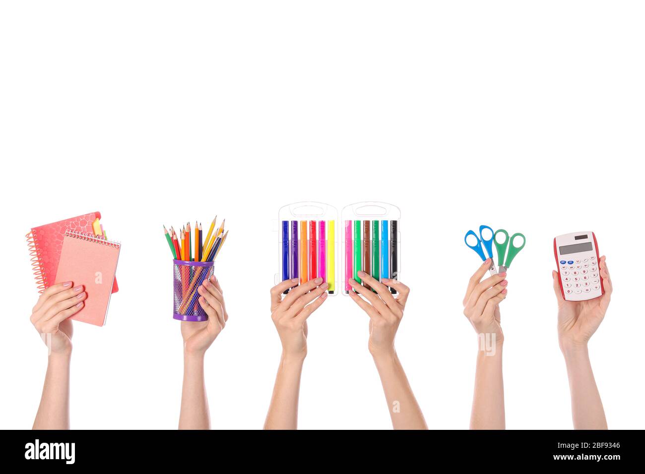 Many hands with school supplies on white background Stock Photo - Alamy