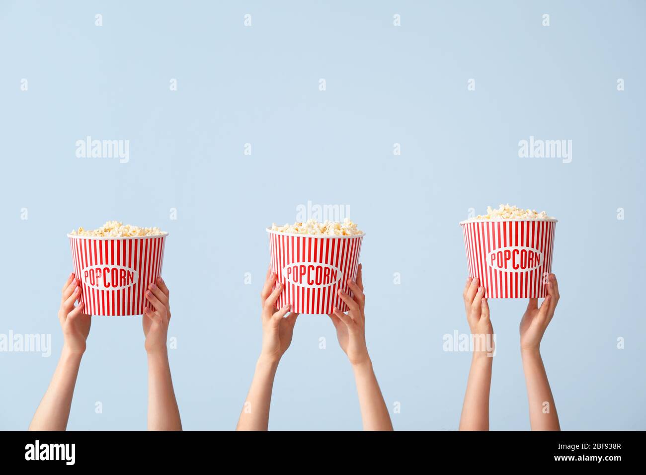 Many hands bucket popcorn hi-res stock photography and images - Alamy