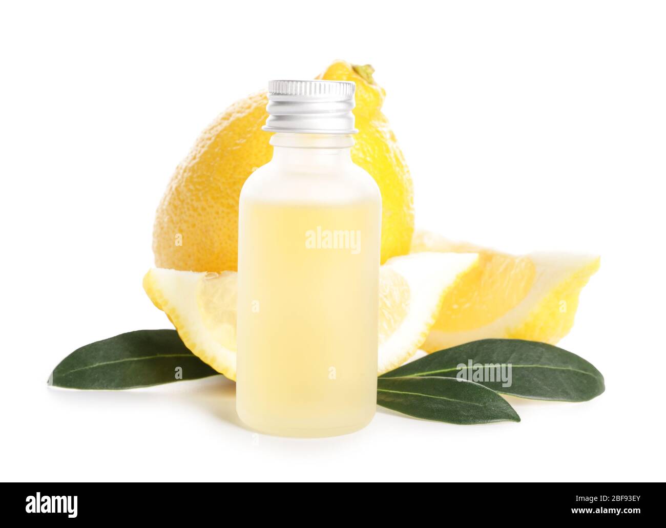 Bottle of lemon essential oil on white background Stock Photo - Alamy