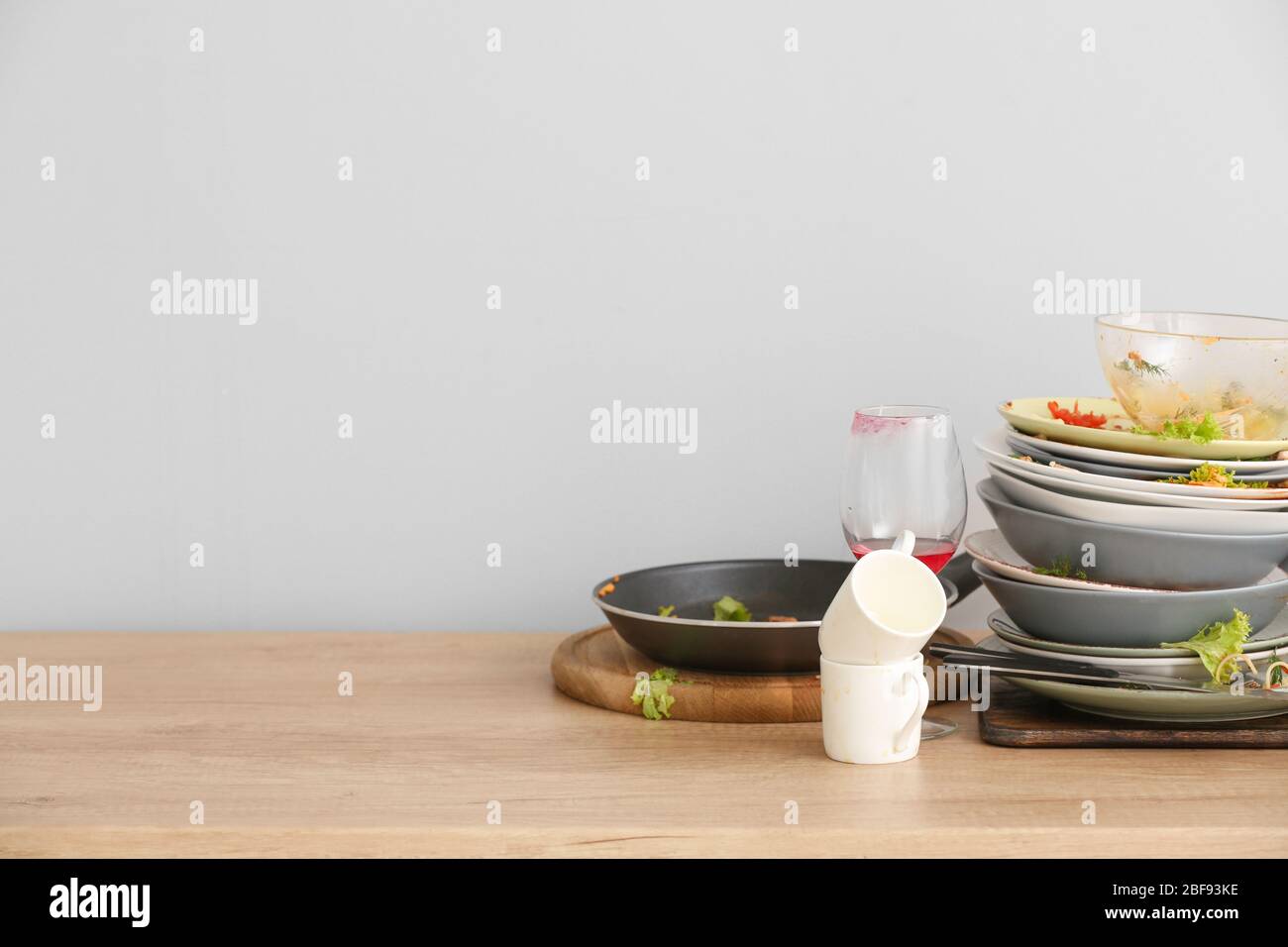 Pile of dirty dishes on kitchen table Stock Photo - Alamy