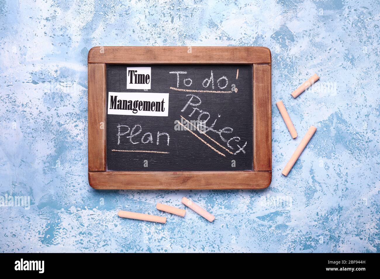 Chalkboard with text on color background. Time management concept Stock ...
