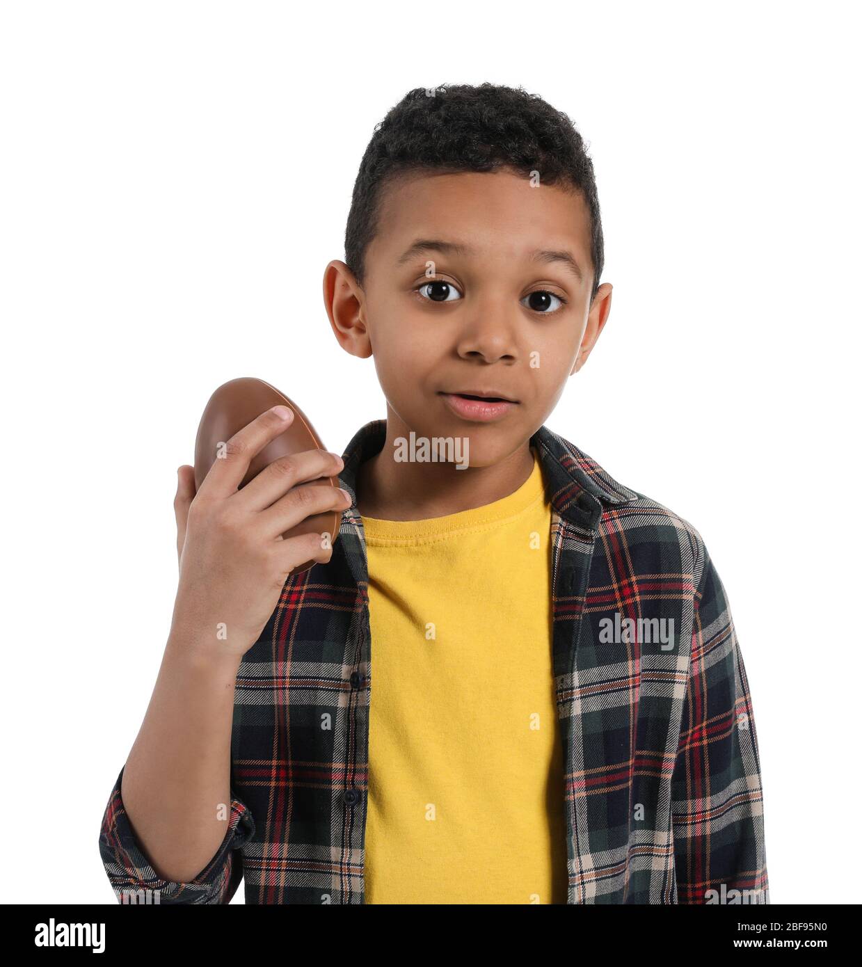 Cute African-American boy with sweet chocolate egg on white background ...