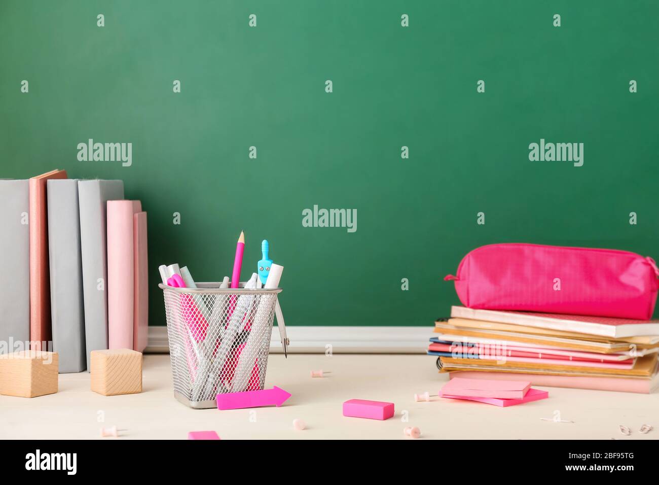 Books and stationery on table in classroom Stock Photo - Alamy
