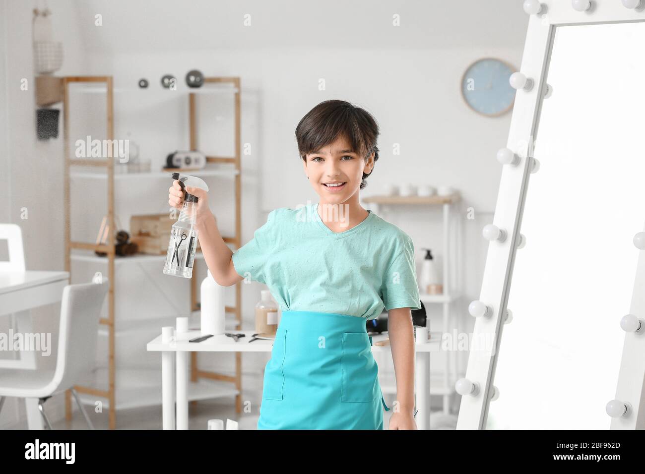 Cute little hairdresser in beauty salon Stock Photo - Alamy