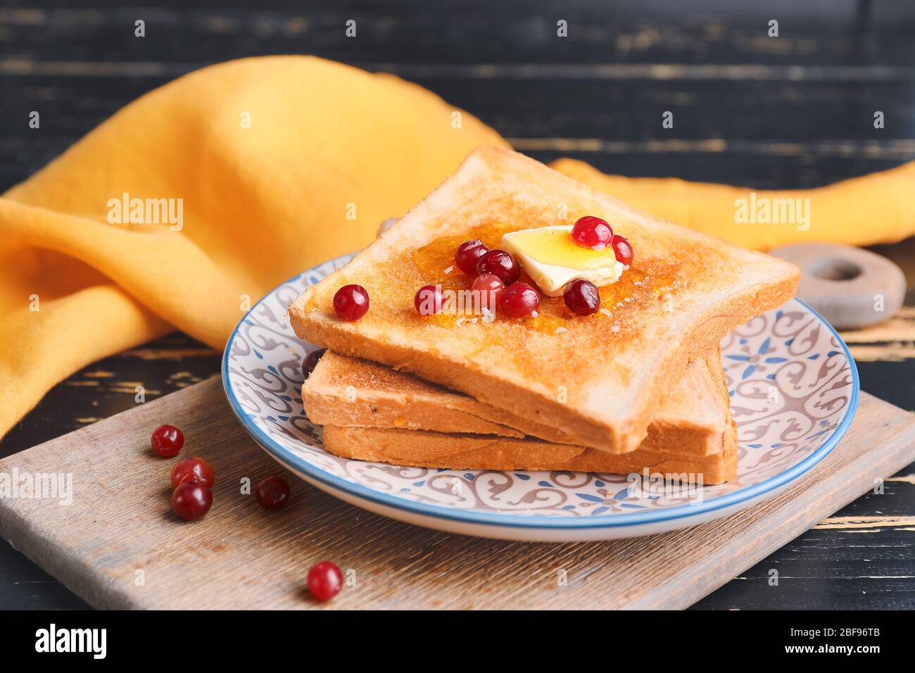 Tasty toasted bread with honey, butter and berries on plate Stock Photo ...