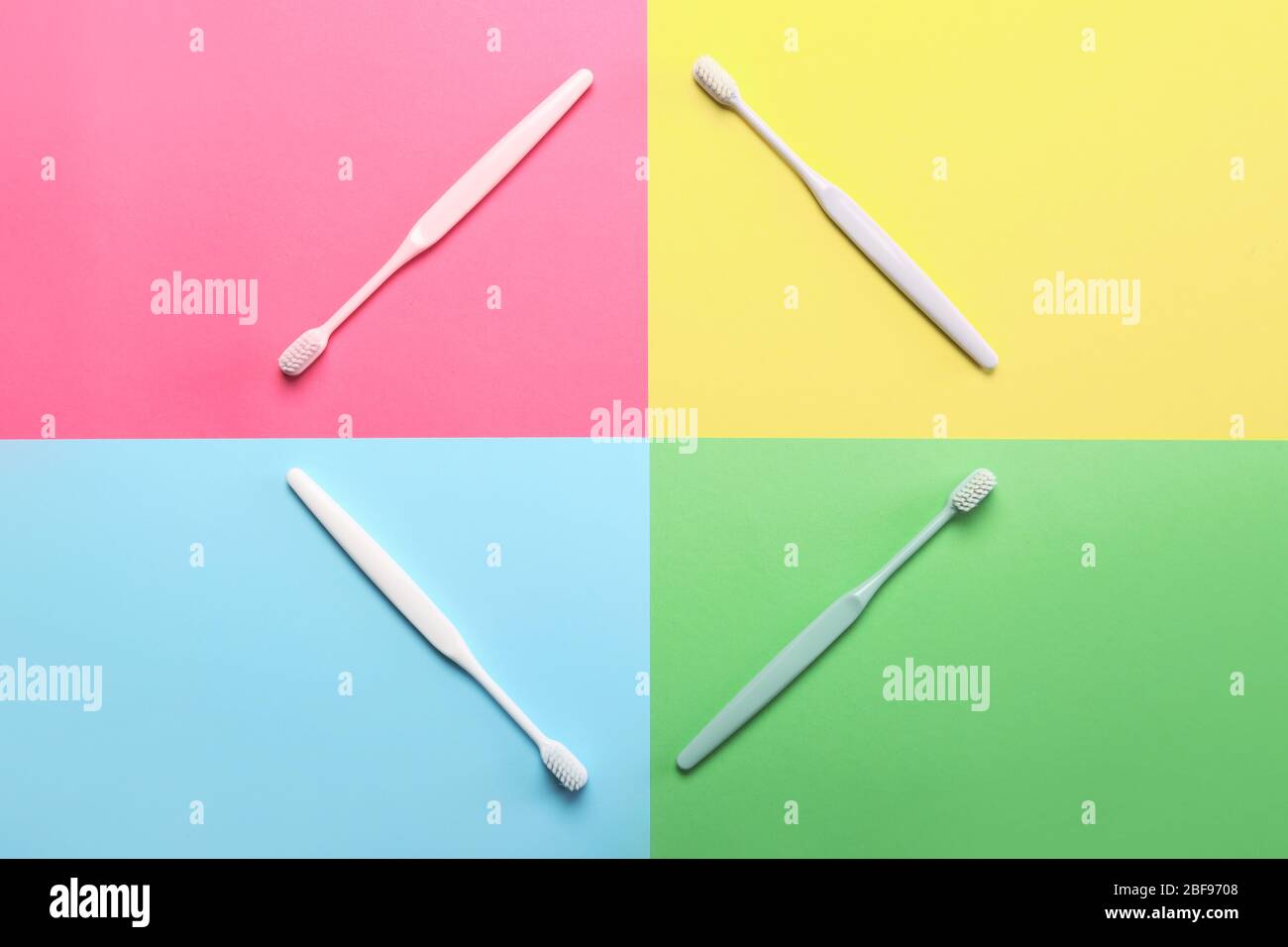 Tooth brushes on color background Stock Photo - Alamy