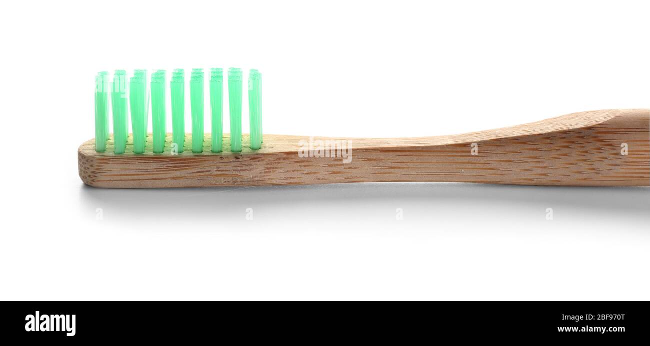 Wooden tooth brush on white background Stock Photo - Alamy