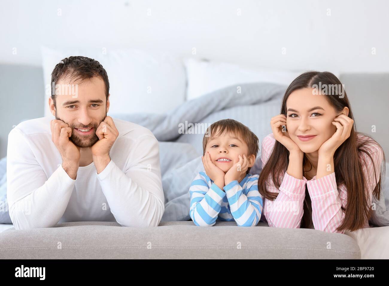 Happy family in bedroom at home Stock Photo - Alamy