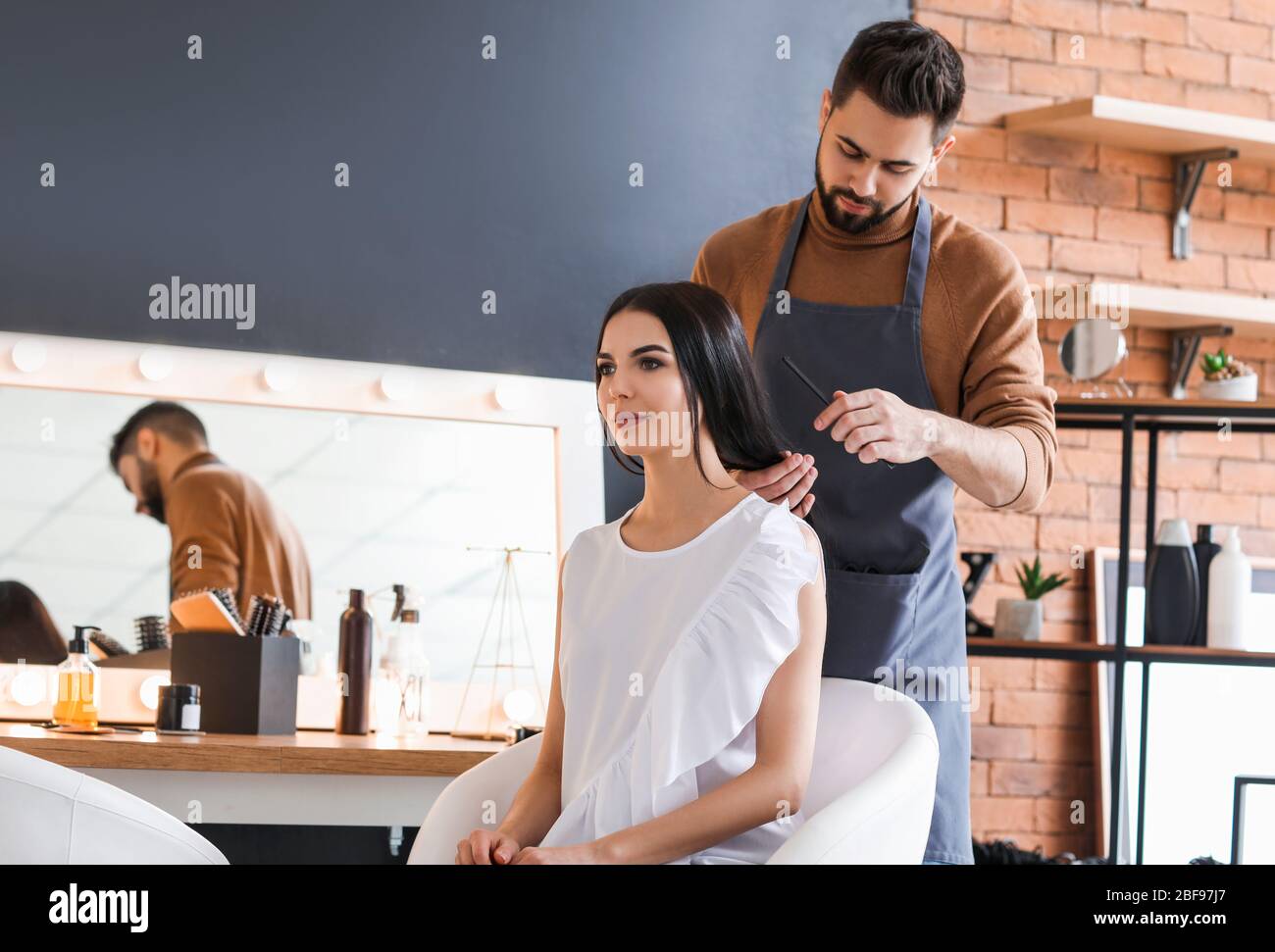 Hairdresser working with client in salon Stock Photo - Alamy
