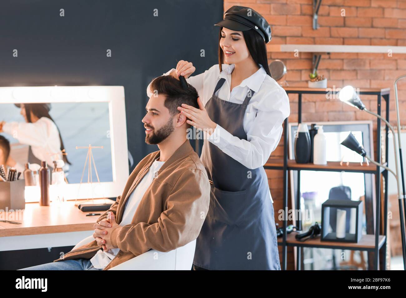 Hairdresser working with client in salon Stock Photo - Alamy