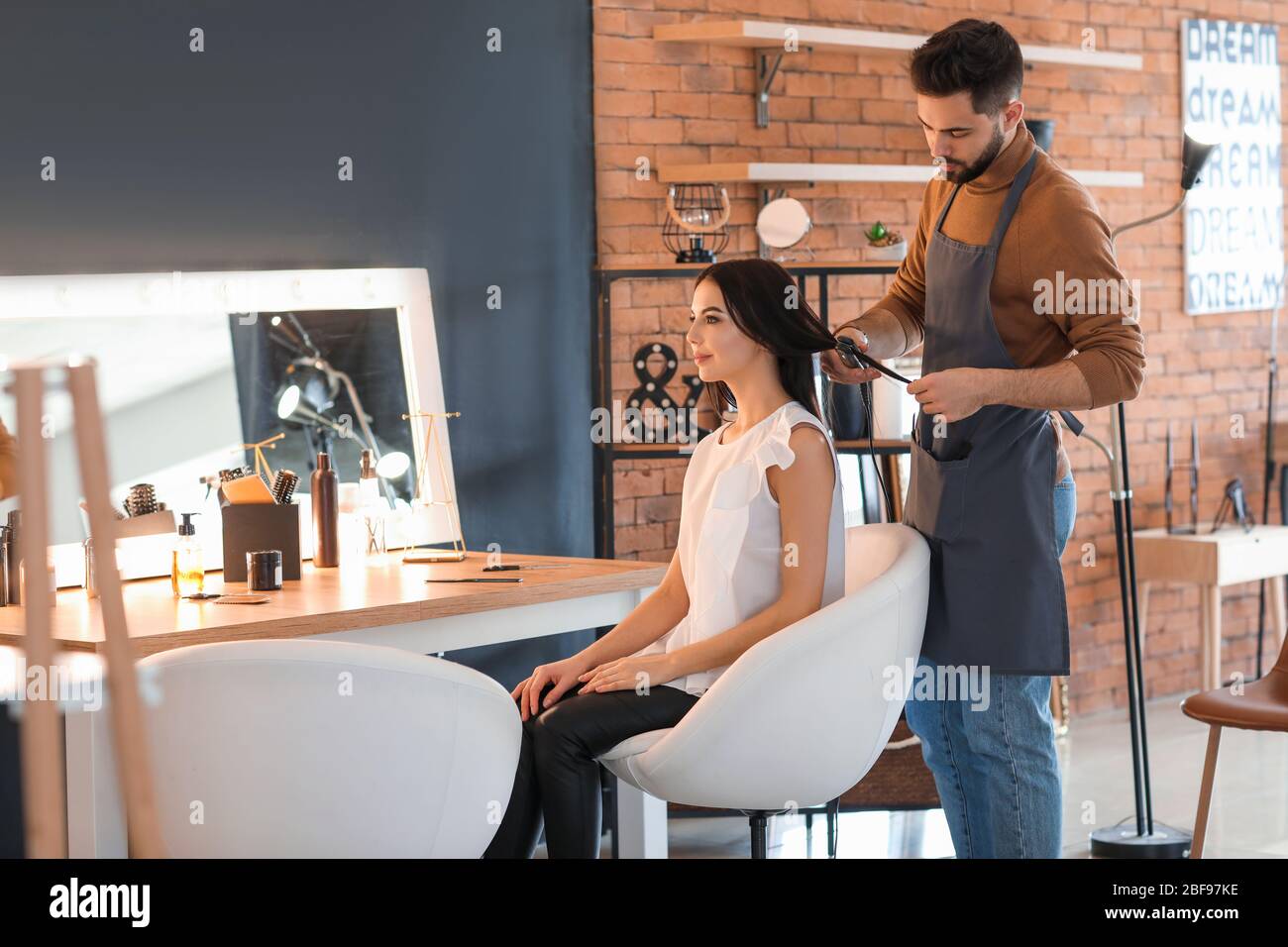 Hairdresser working with client in salon Stock Photo - Alamy