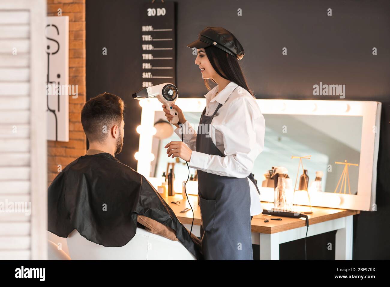 Hairdresser working with client in salon Stock Photo - Alamy