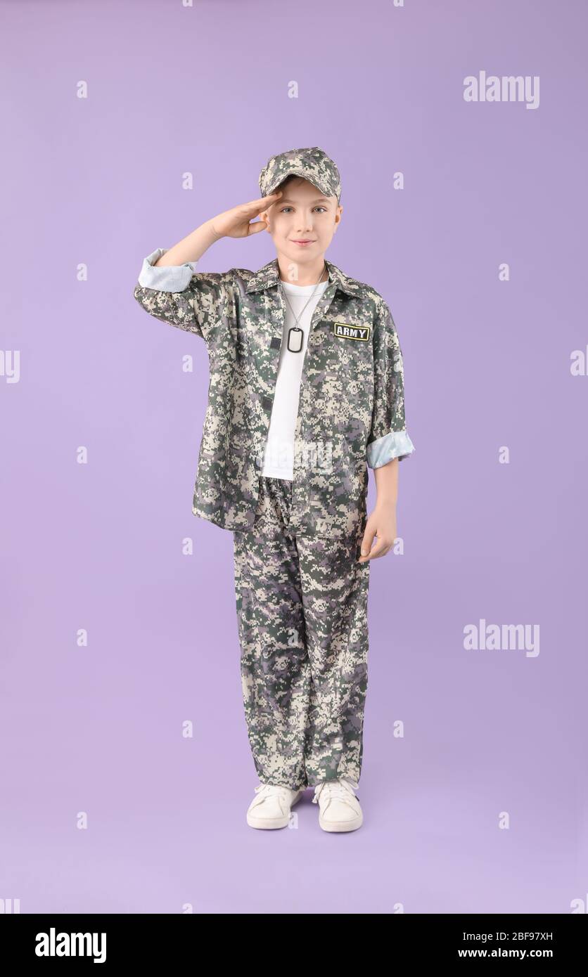 Cute saluting little soldier on color background Stock Photo - Alamy