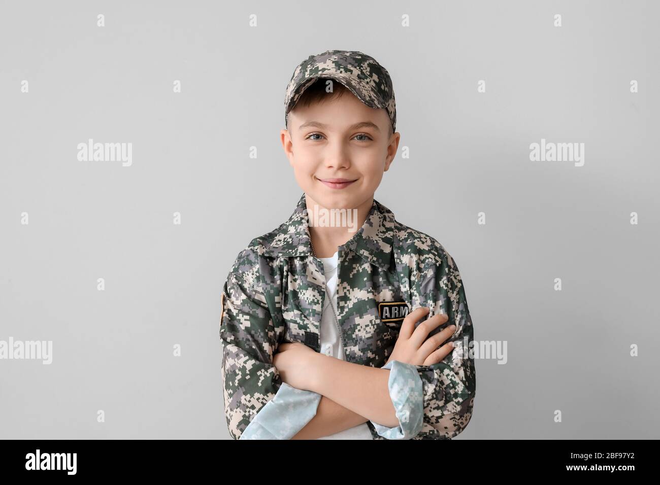 Cute little soldier on light background Stock Photo - Alamy