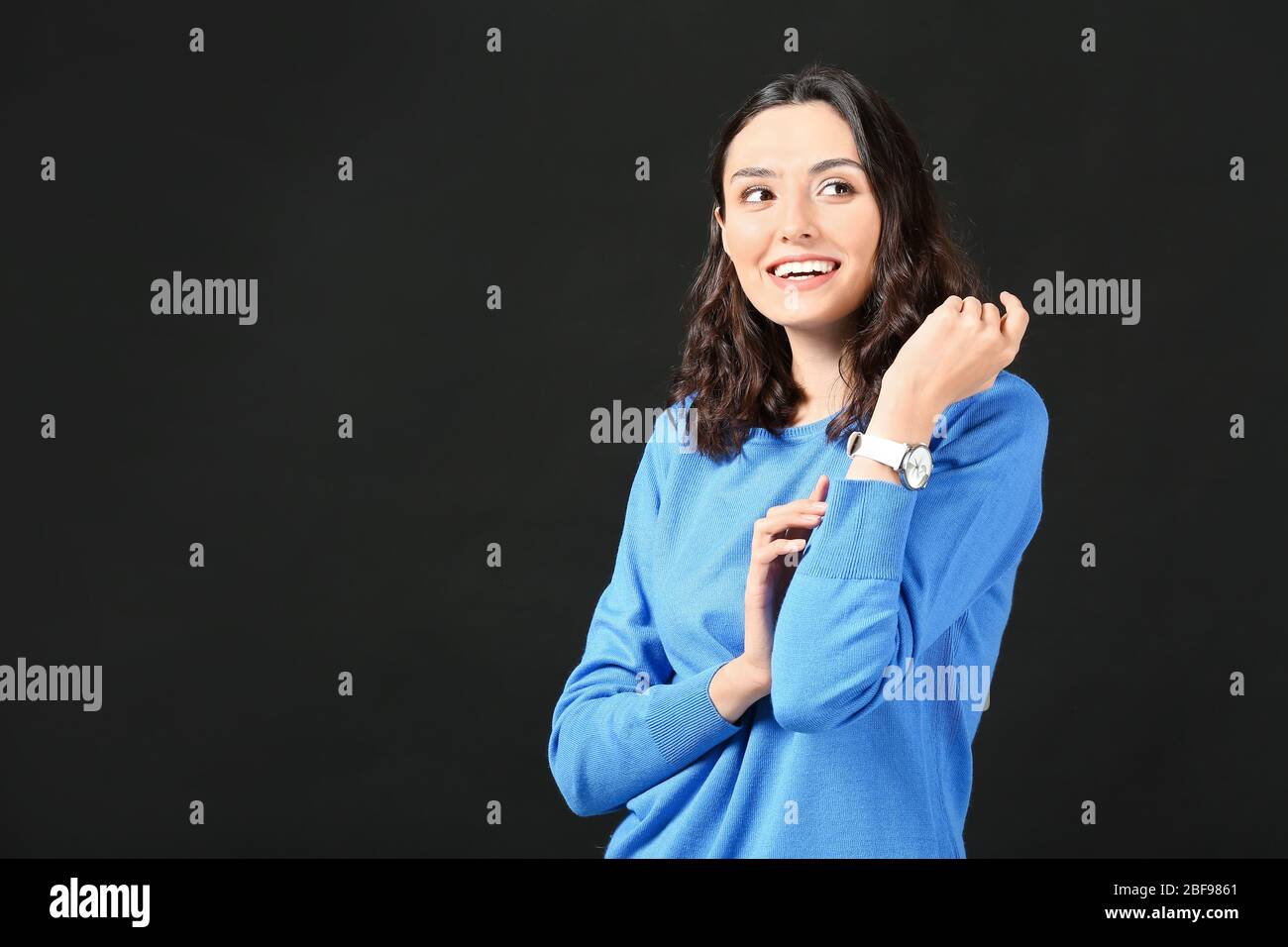 Woman with watch on dark background. Time management concept Stock ...