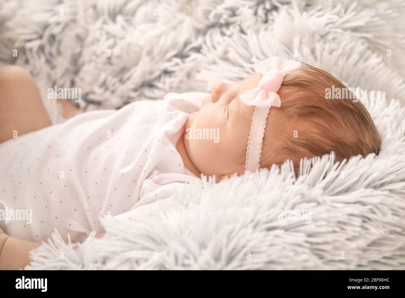 Cute little baby girl lying on plaid Stock Photo - Alamy
