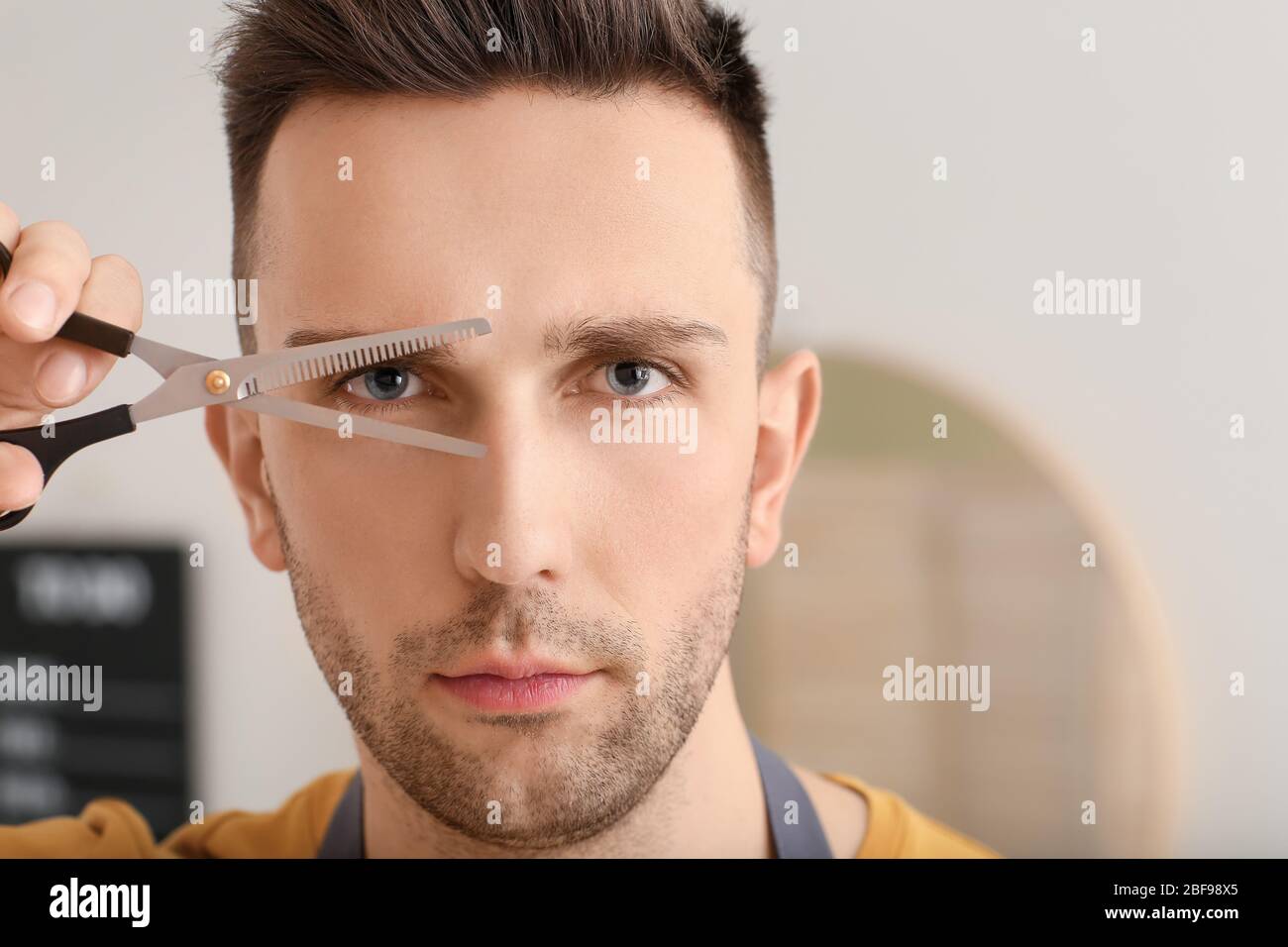 Portrait of male hairdresser in salon Stock Photo - Alamy
