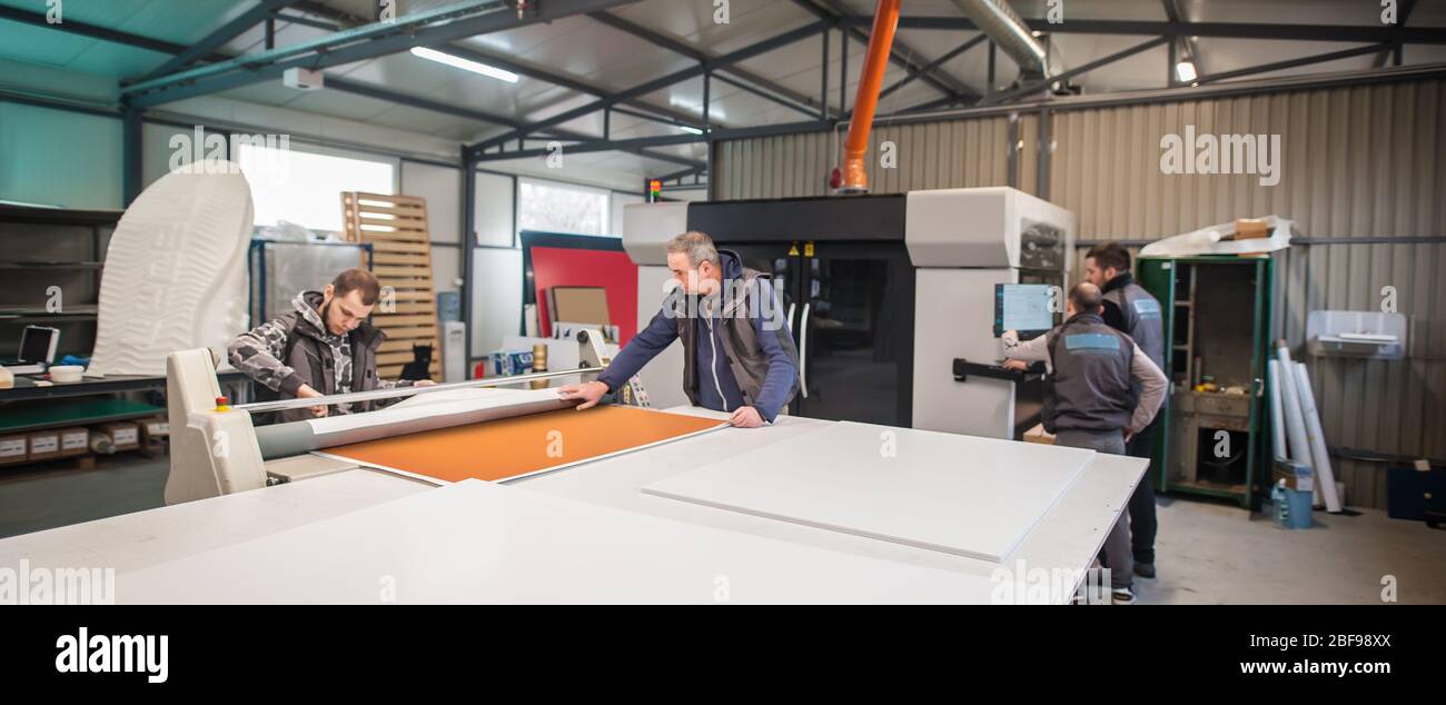 Large group of worker printmaker technician operator works in digital ...