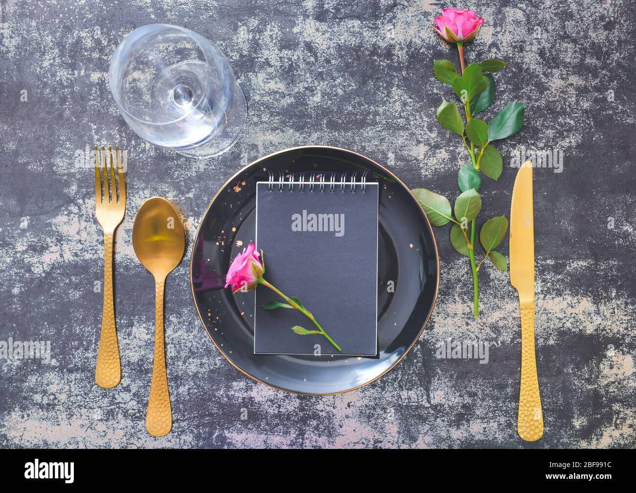 Beautiful simple table setting on dark background Stock Photo - Alamy