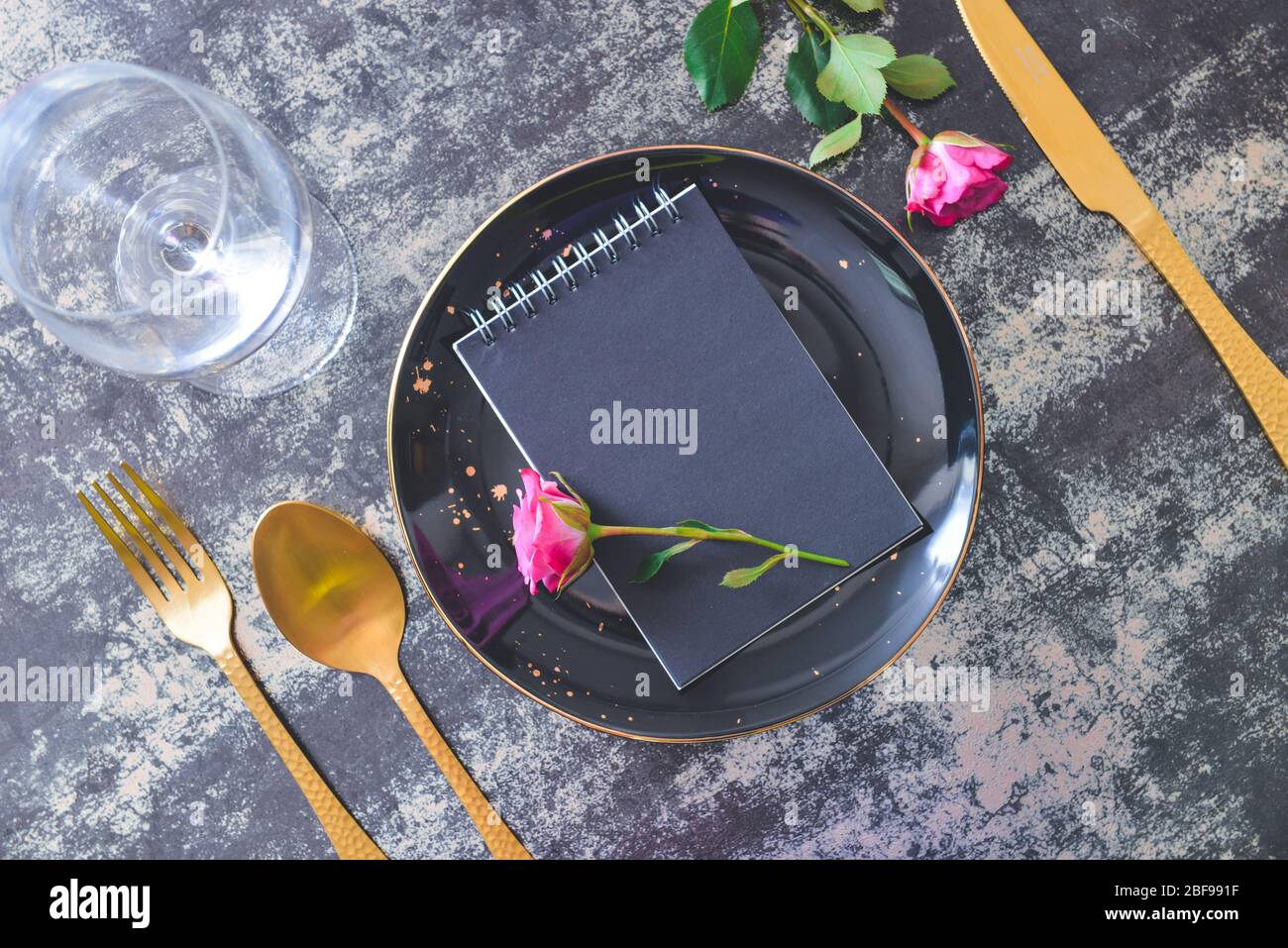 Beautiful simple table setting on dark background Stock Photo - Alamy