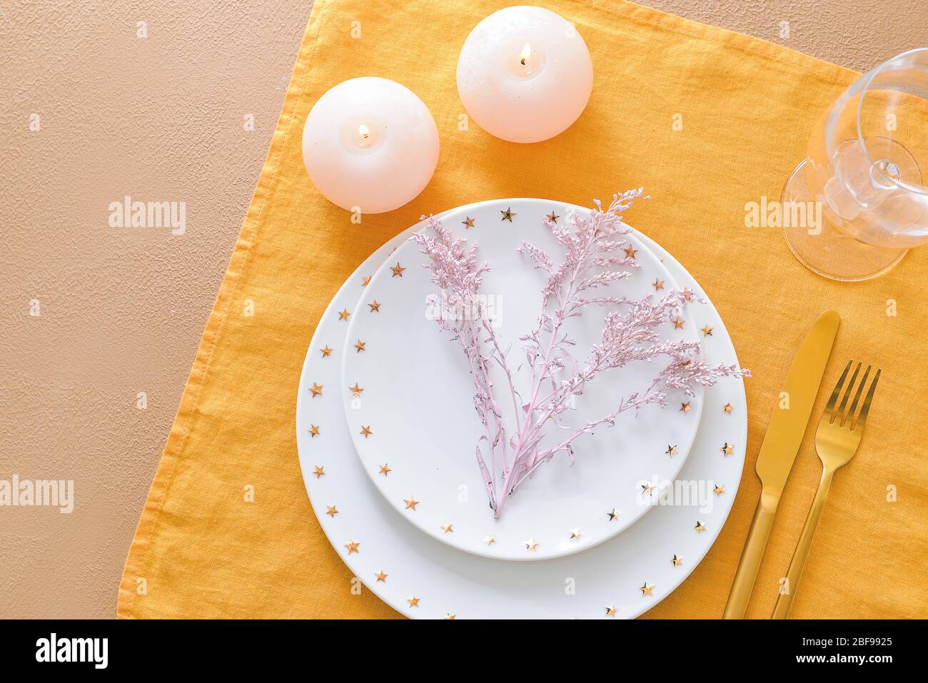 Beautiful simple table setting on color background Stock Photo - Alamy