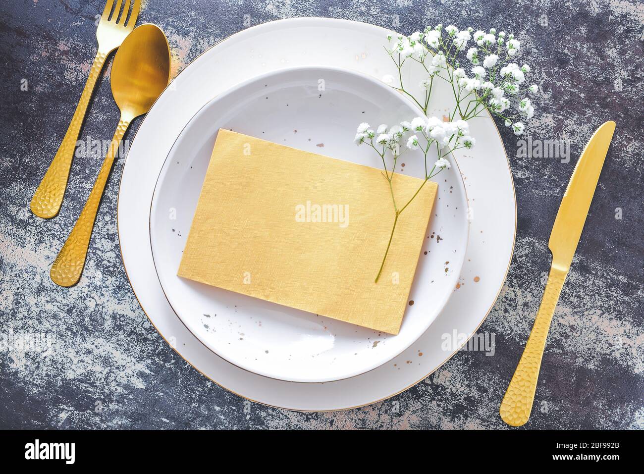 Beautiful simple table setting on dark background Stock Photo - Alamy