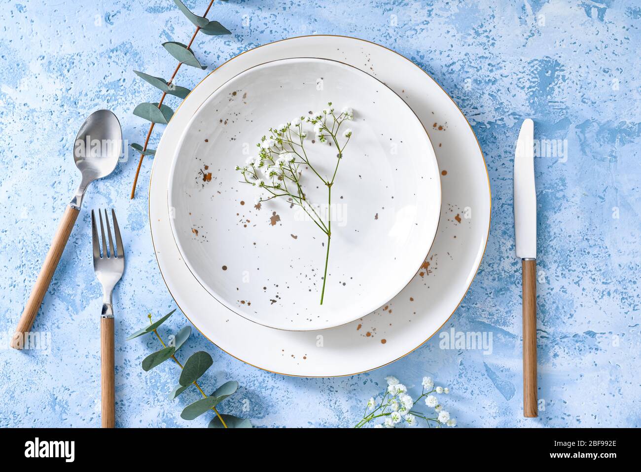 Beautiful simple table setting on color background Stock Photo - Alamy