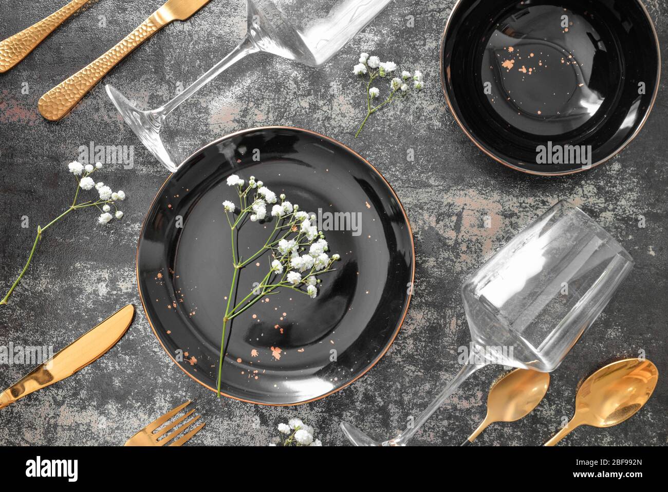 Beautiful simple table setting on dark background Stock Photo - Alamy