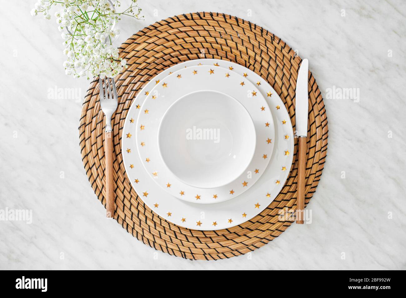 Beautiful simple table setting on white background Stock Photo - Alamy
