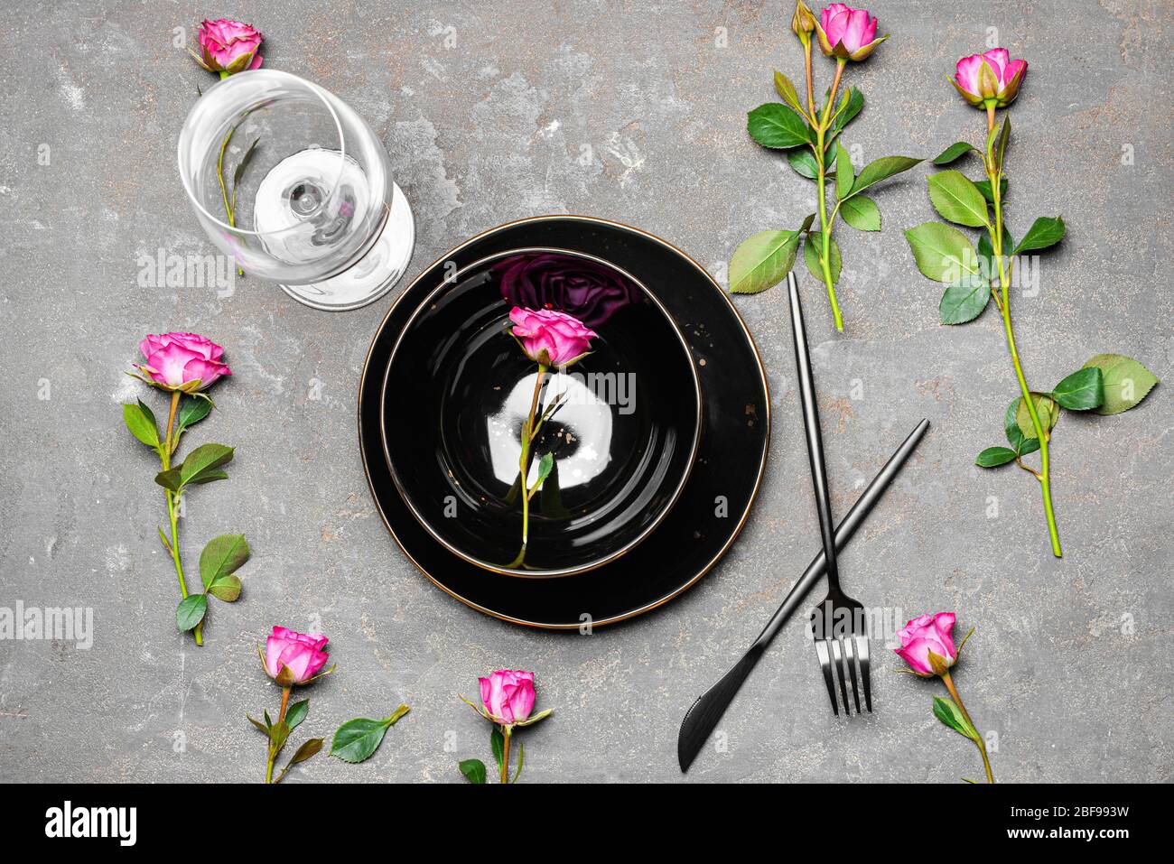Beautiful simple table setting on grey background Stock Photo - Alamy