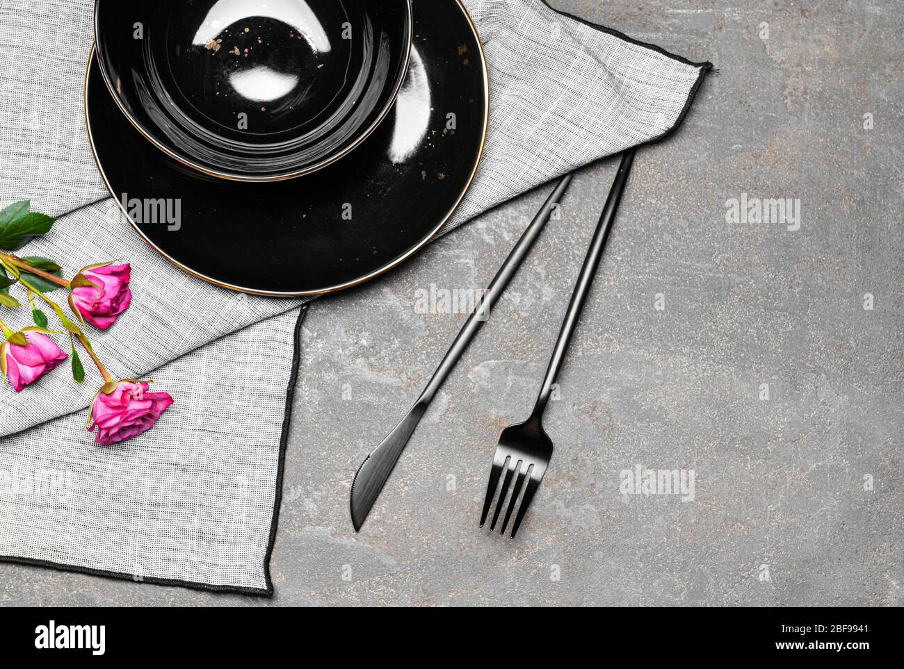 Beautiful simple table setting on grey background Stock Photo - Alamy