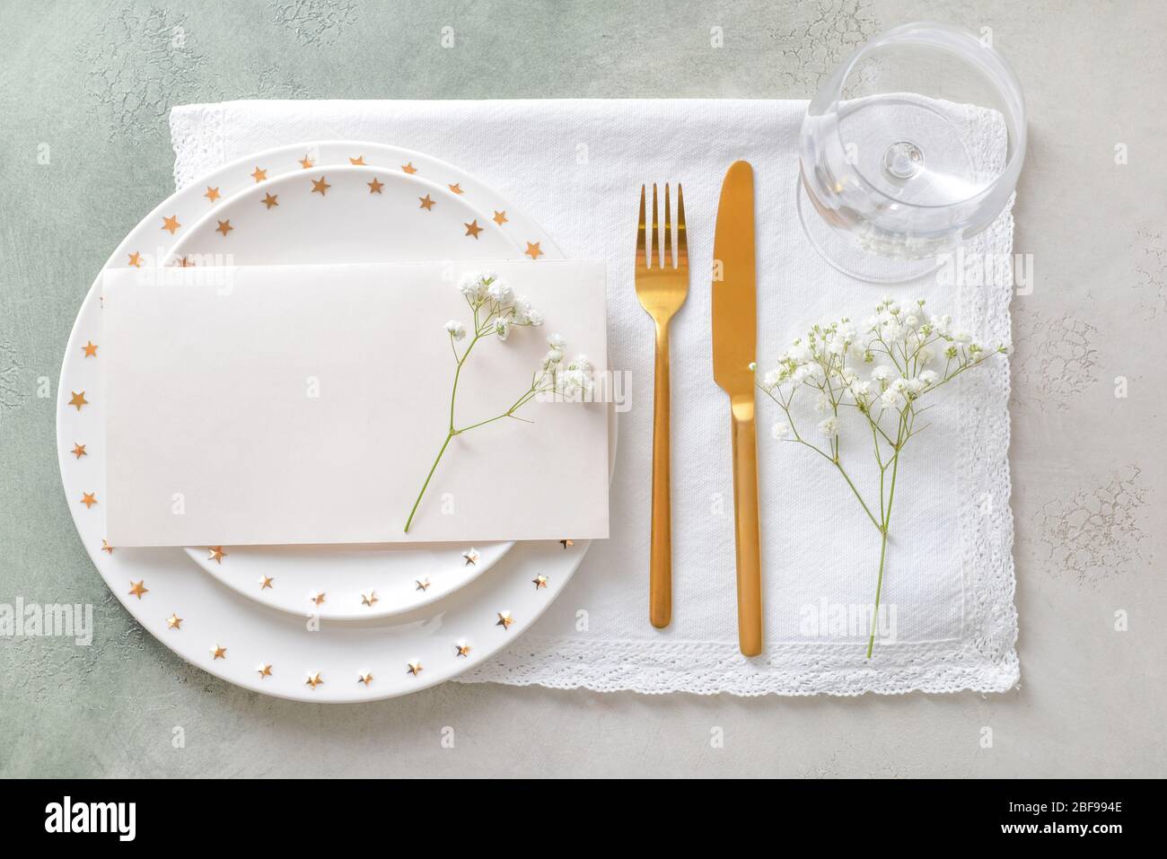 Beautiful simple table setting on light background Stock Photo - Alamy