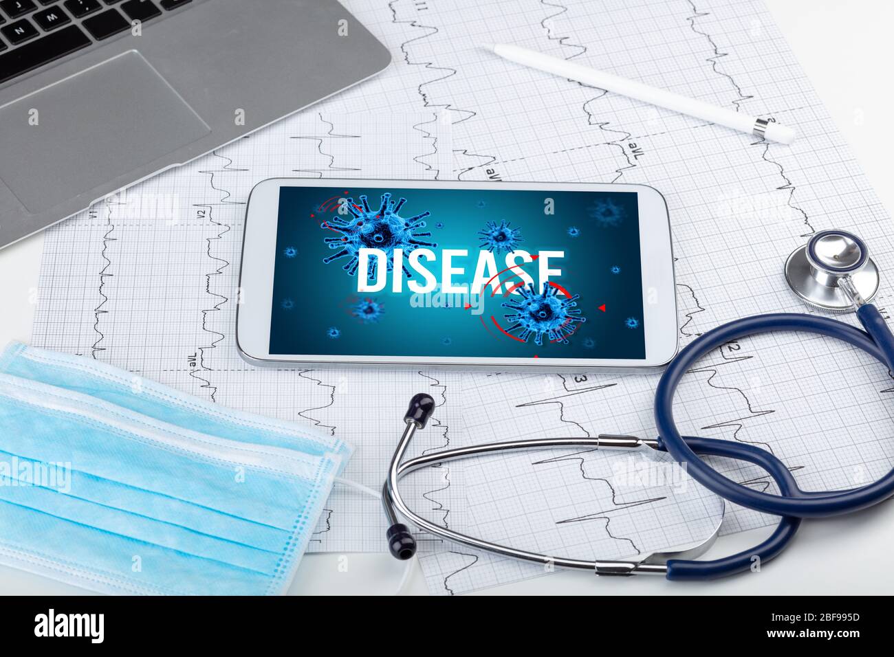 Tablet pc and doctor tools on white surface with DISEASE inscription ...