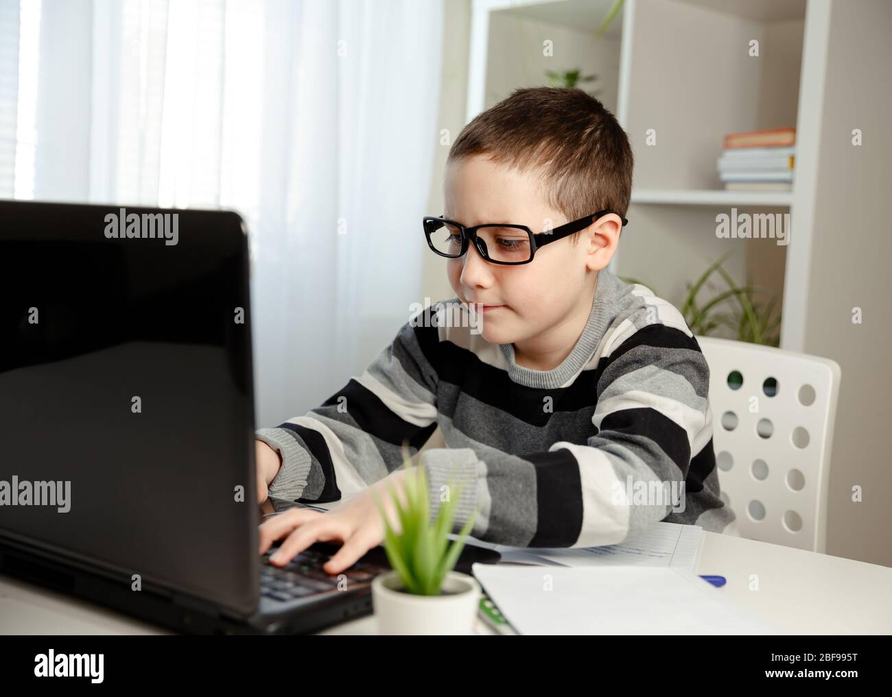 Online education and distance learning Schoolboy doing school homework ...
