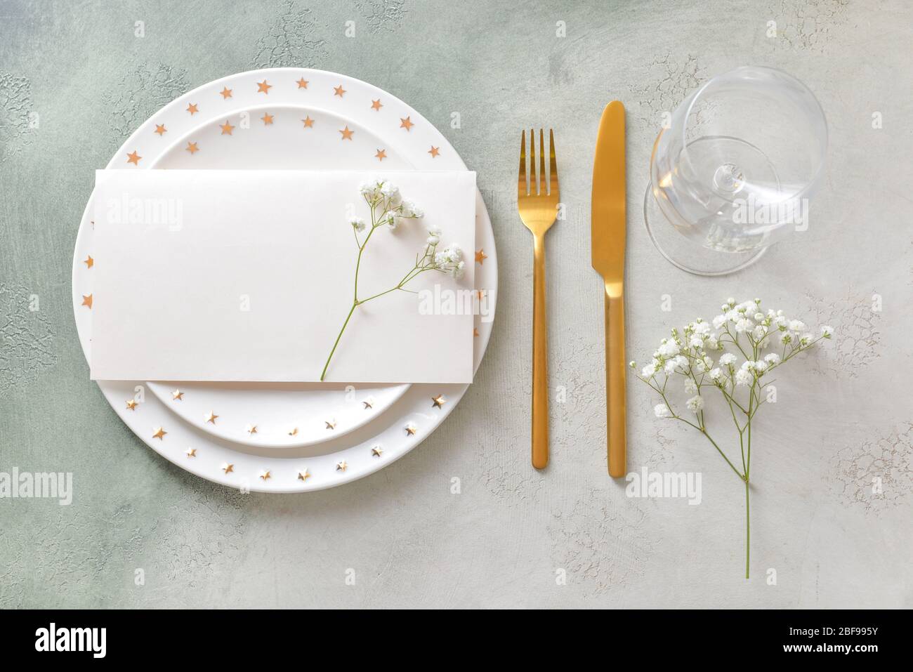 Beautiful simple table setting on light background Stock Photo - Alamy