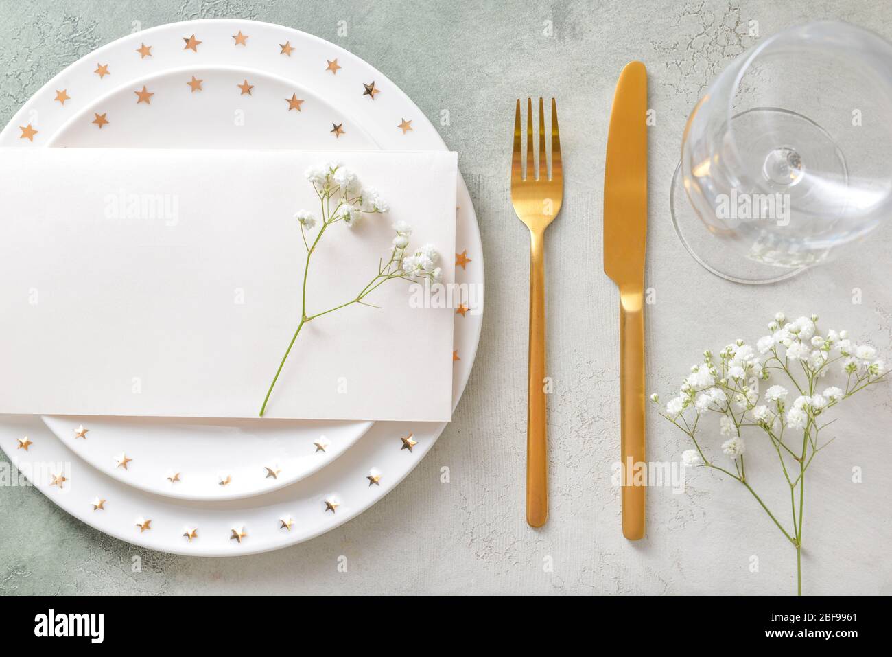 Beautiful simple table setting on light background Stock Photo - Alamy