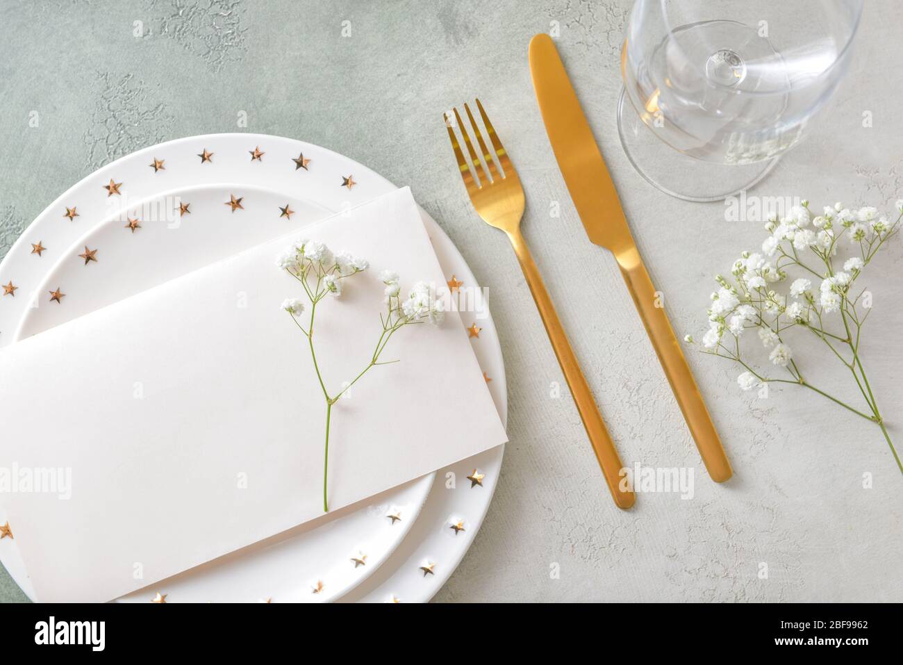 Beautiful simple table setting on light background Stock Photo - Alamy